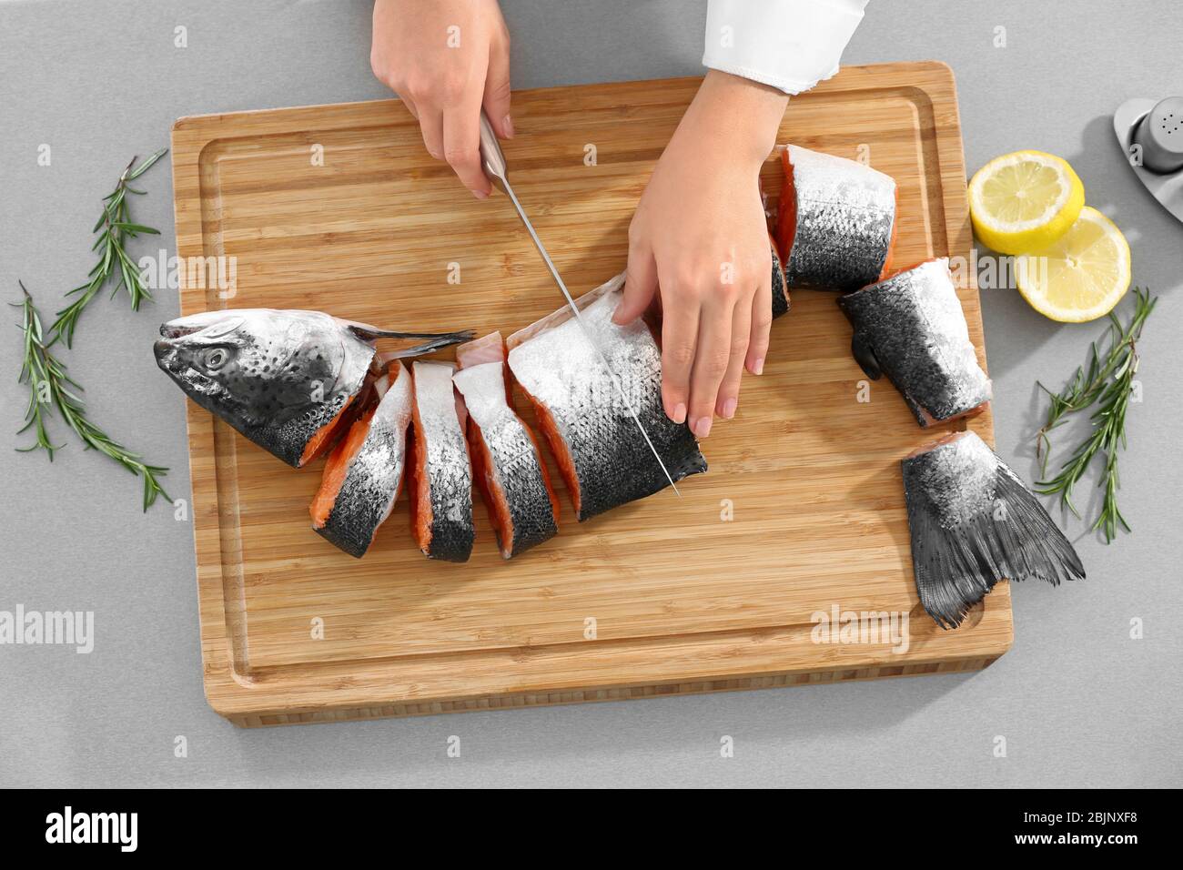 Woman cut salmon steak hi-res stock photography and images - Alamy
