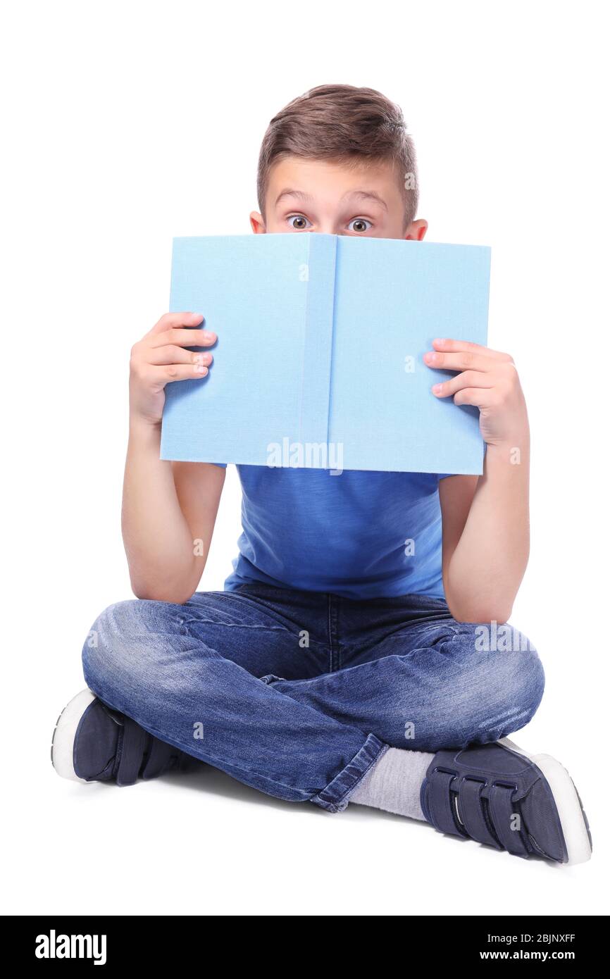Cute little boy with book on white background Stock Photo - Alamy
