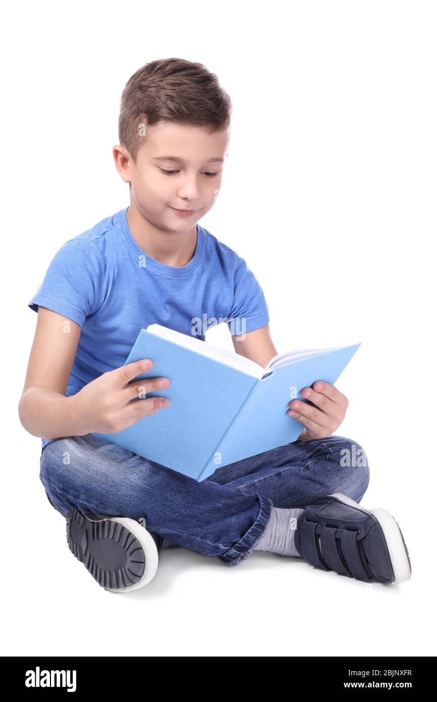Cute little boy reading book on white background Stock Photo - Alamy