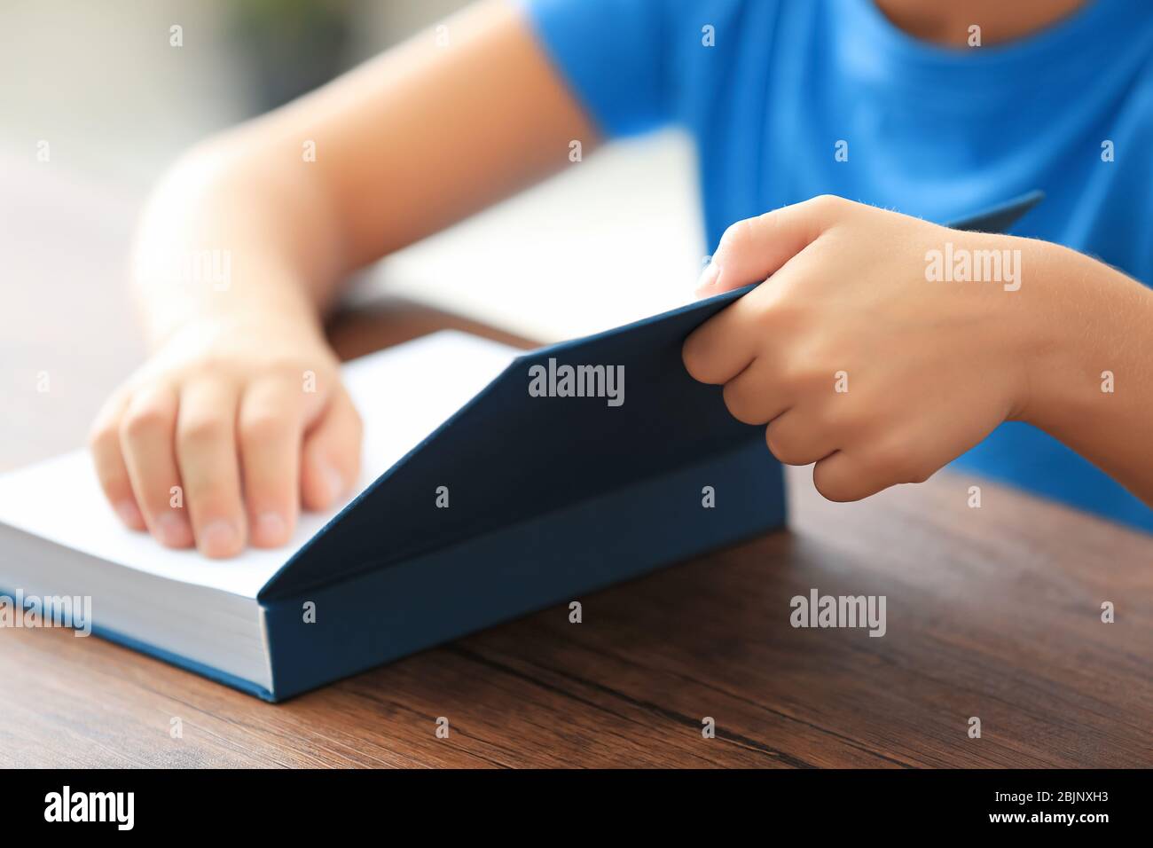 Cute little child reading book at home, closeup Stock Photo - Alamy