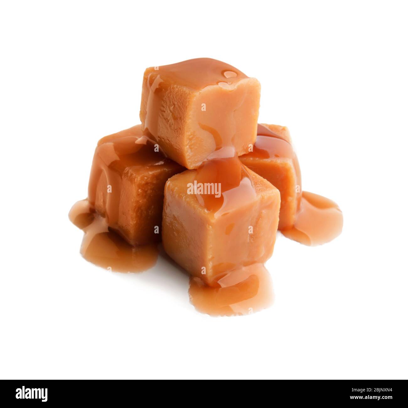 Sweet candies with caramel topping on white background Stock Photo - Alamy