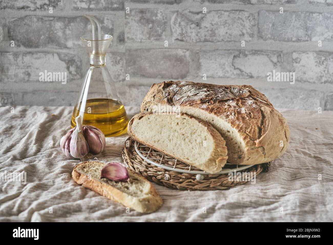 Homemade traditional village bread baked and sliced with olive oil and ...