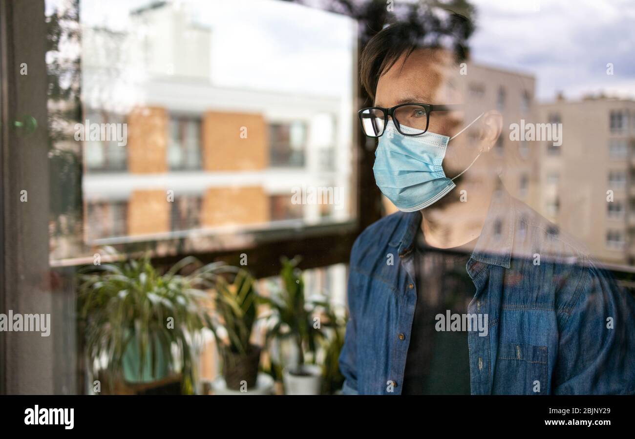 Man looking through window house sad hi-res stock photography and ...