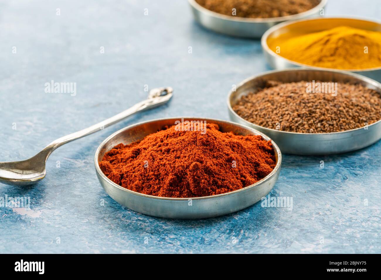 Ground spices in pots - paprika, nutmeg, tumeric and cumin - closeup ...