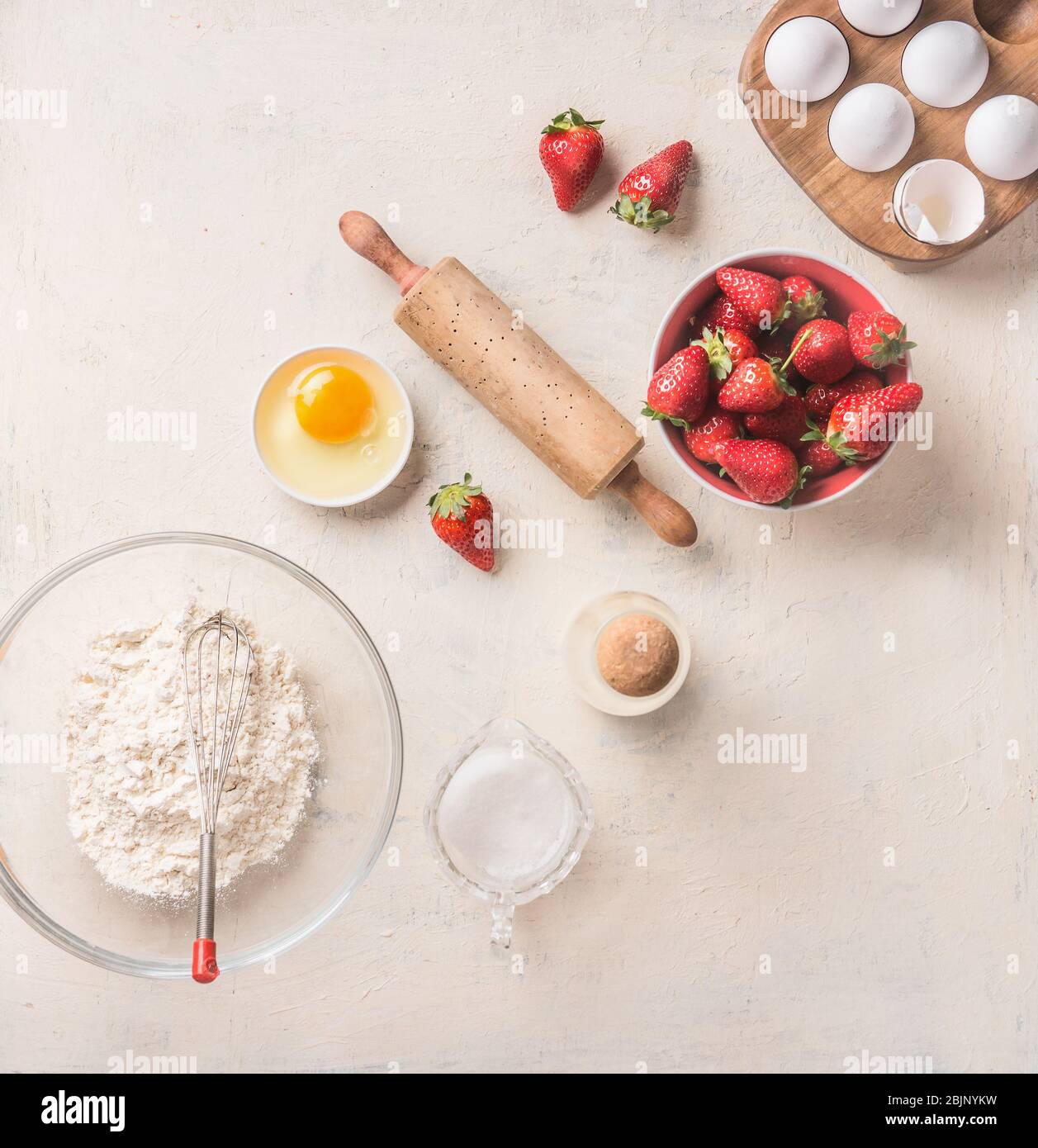 Baking background with flour, eggs,rolling pin and strawberries on ...