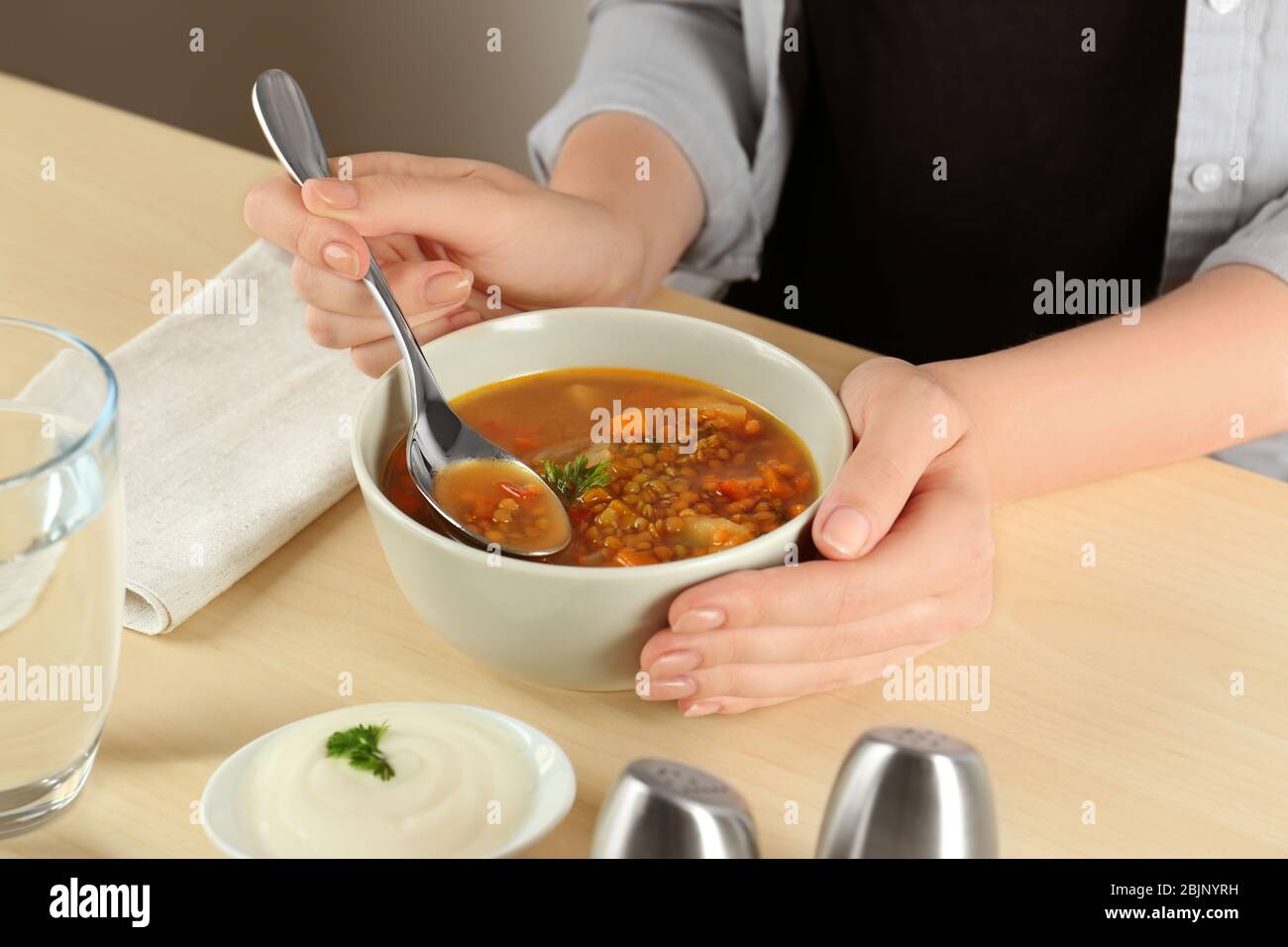Woman eating bowl of stew hi-res stock photography and images - Alamy