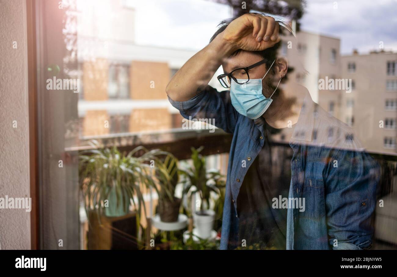 Man looking through window house sad hi-res stock photography and ...