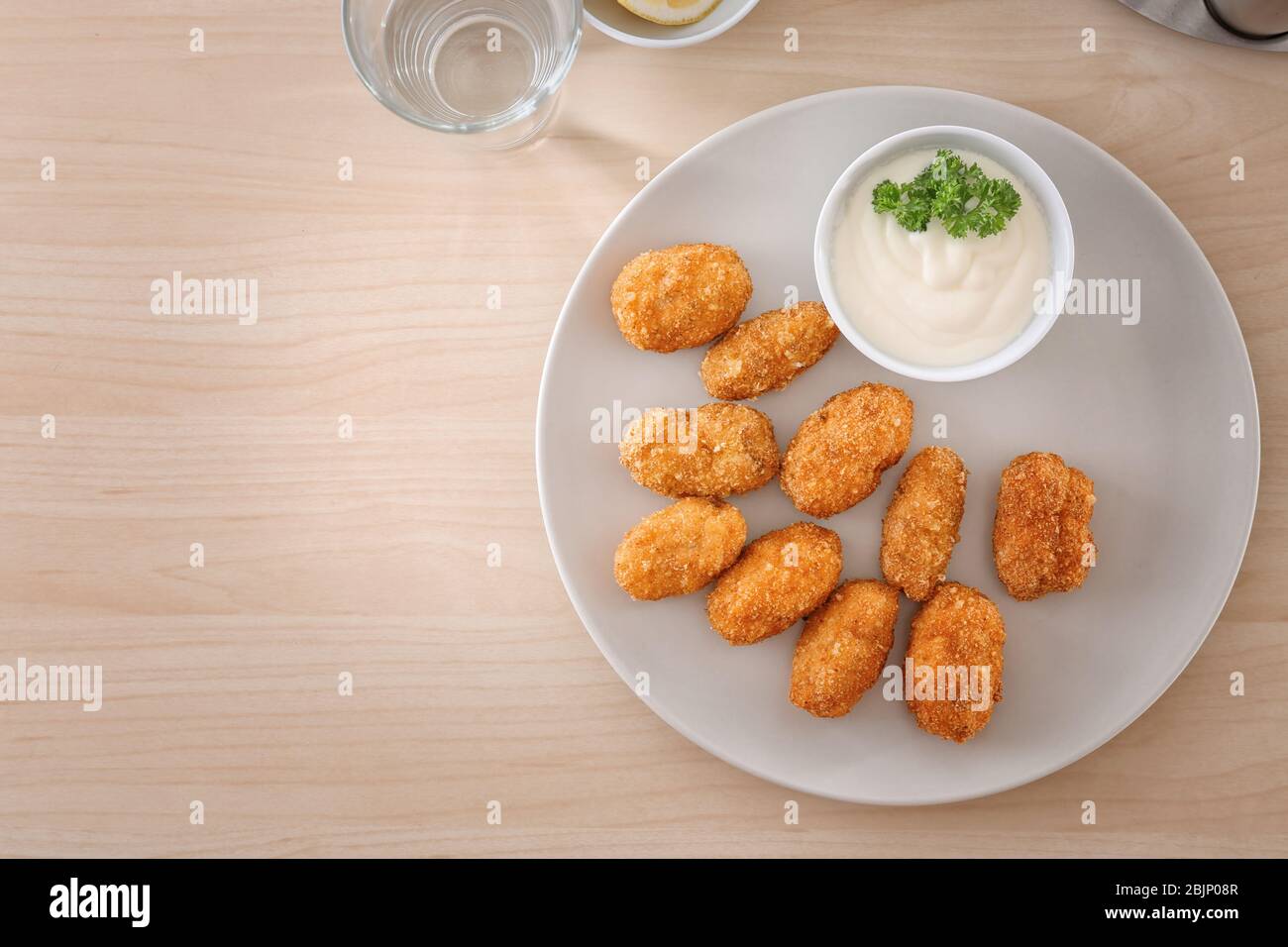 Plate with delicious salmon croquettes on table Stock Photo - Alamy