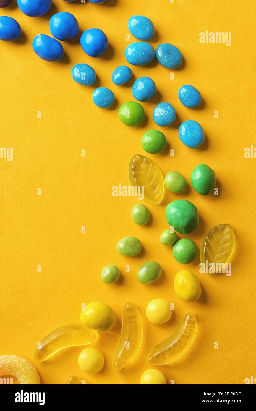 Colorful candies arranged as semi circle on yellow background Stock ...