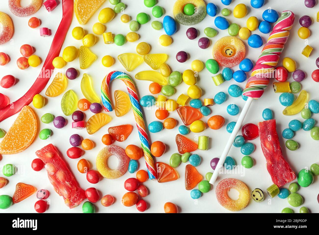 Colorful candies scattered on light background Stock Photo - Alamy