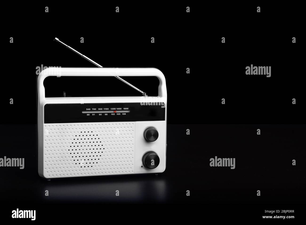 Retro radio on black background Stock Photo - Alamy