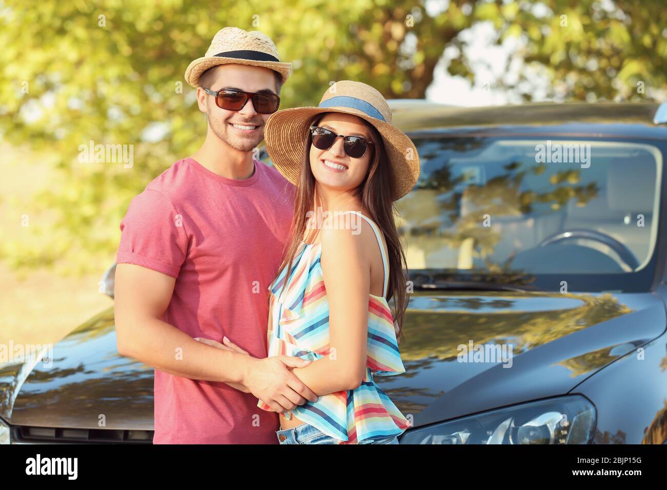 Young couple standing near car hi-res stock photography and images - Alamy