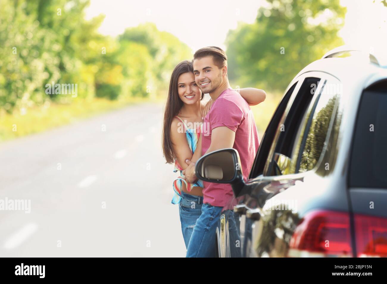 Young couple standing near car hi-res stock photography and images - Alamy