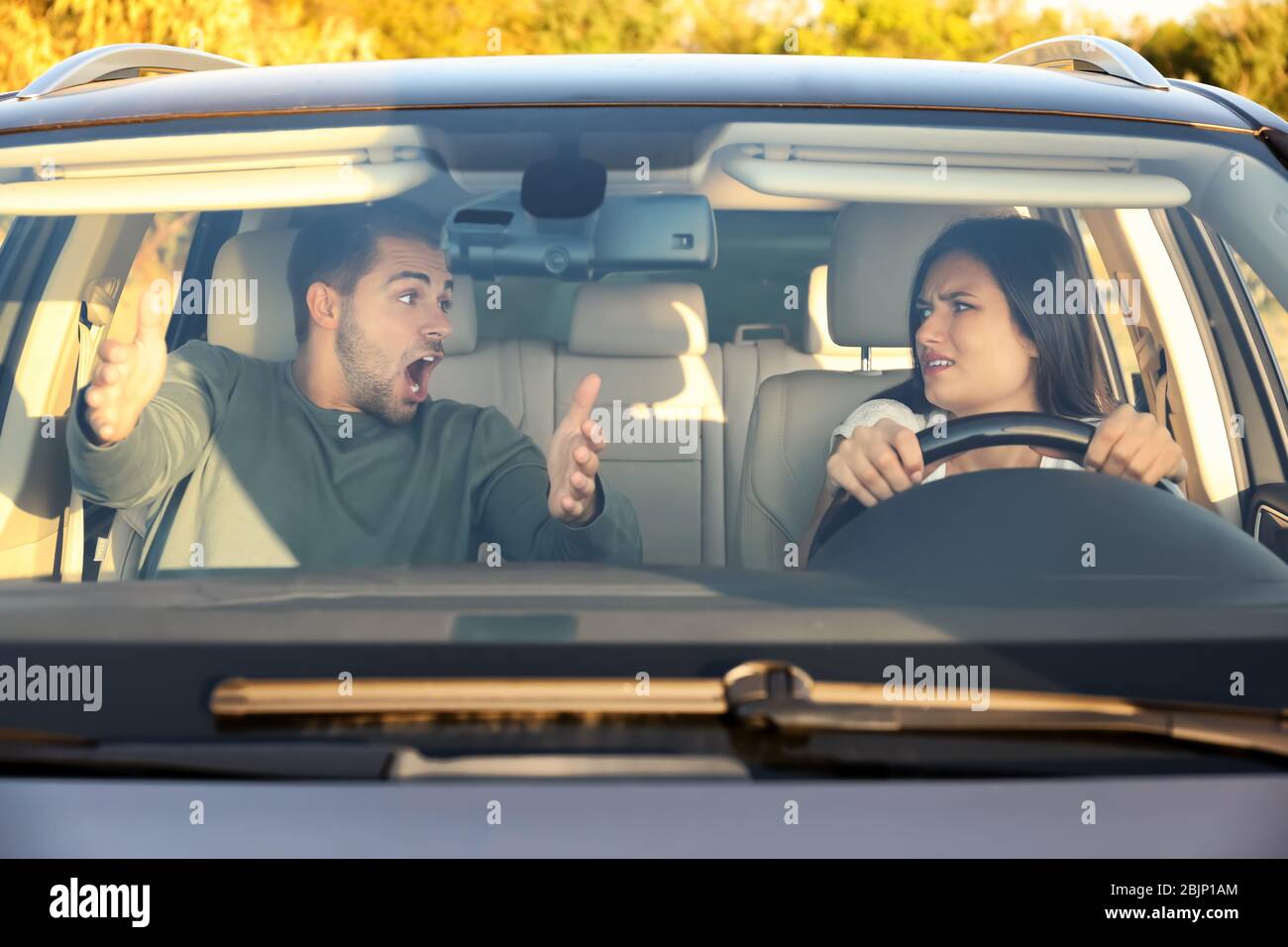 Emotional young couple in car during auto accident Stock Photo - Alamy