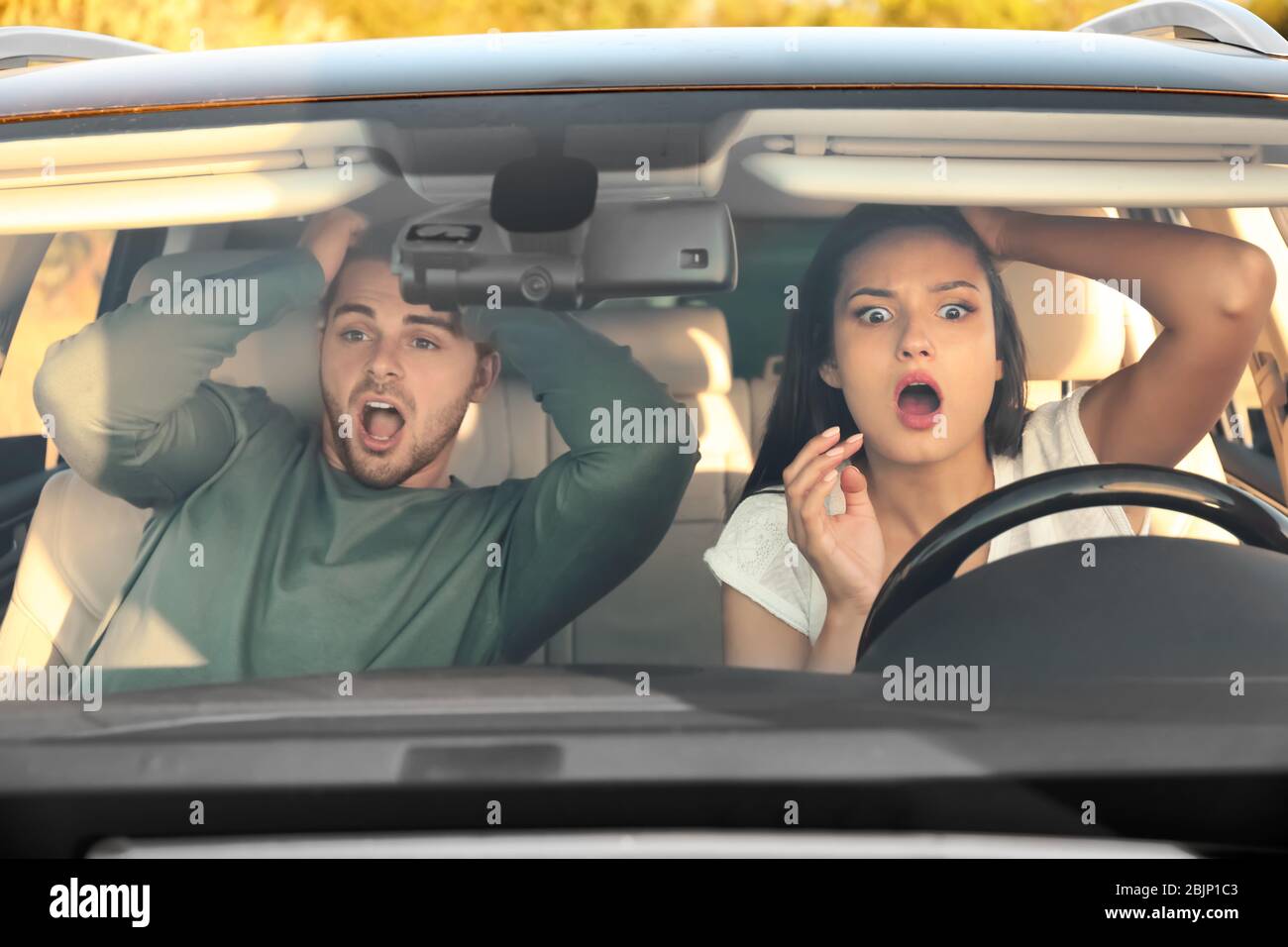 Emotional young couple in car during auto accident Stock Photo - Alamy