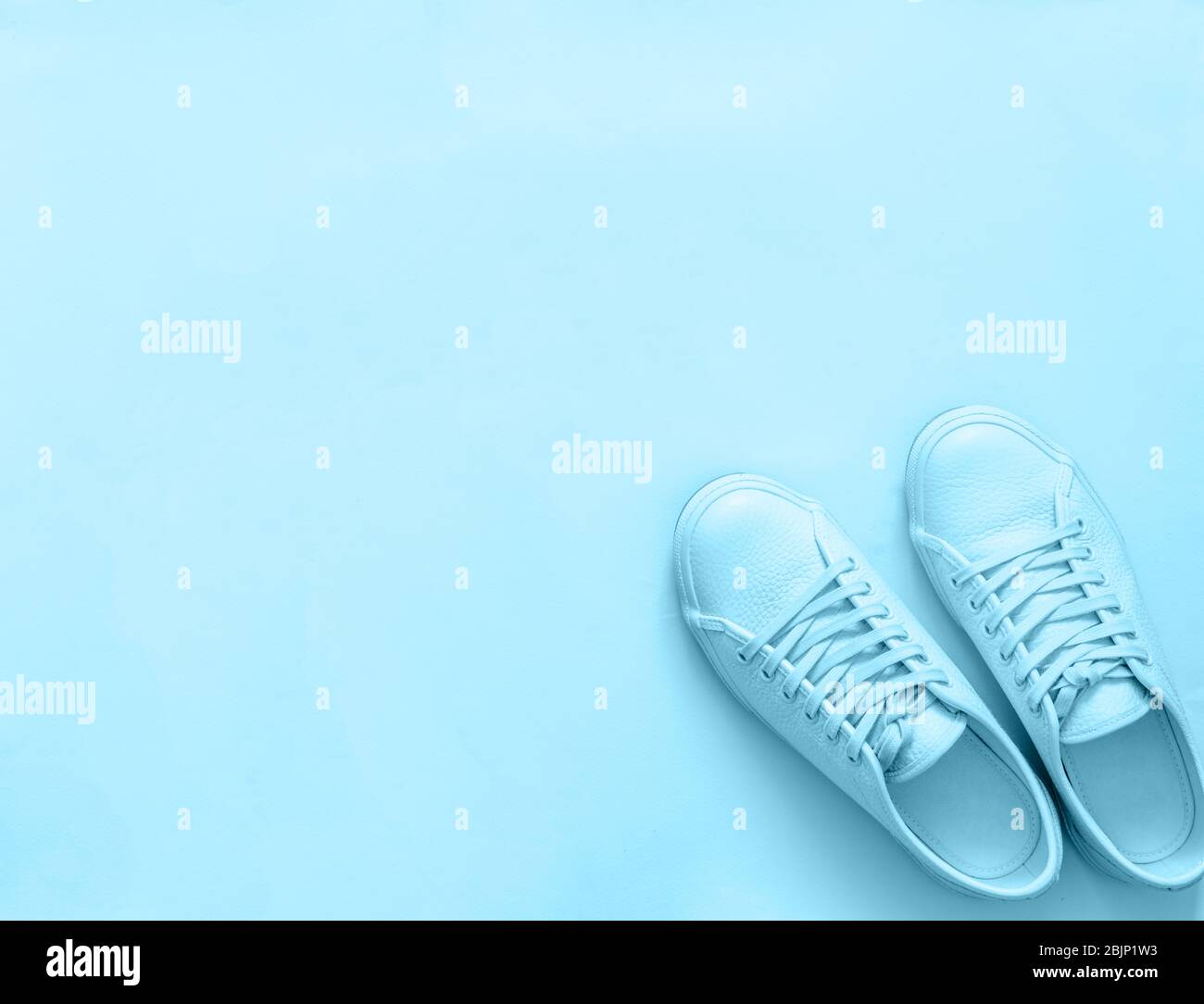 Blue leather sneakers on blue background. Pair of blue sport shoes or ...