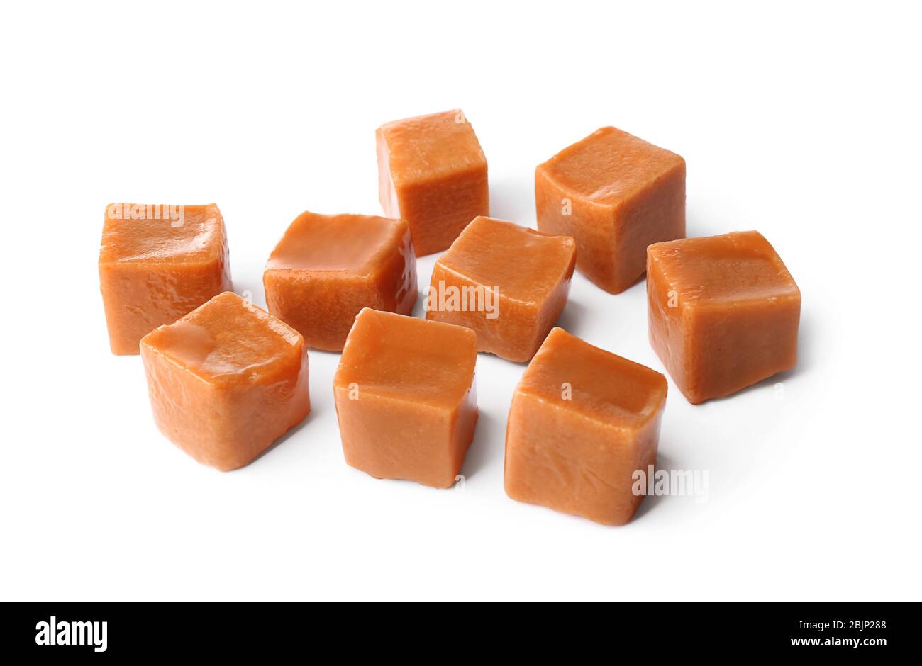 Sweet caramel candies on white background Stock Photo - Alamy