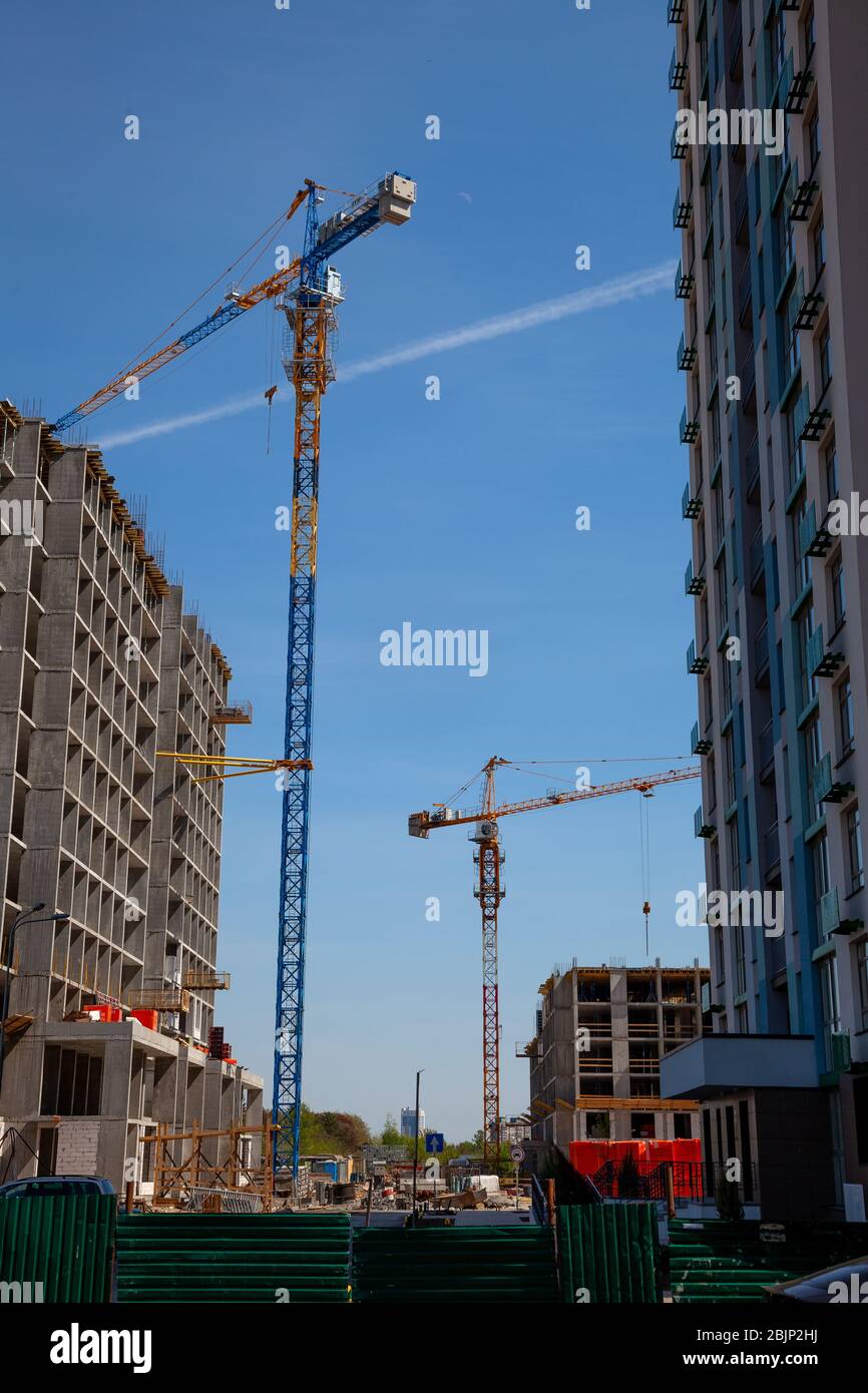 Cranes at the construction site of multi-unit high buildings ...