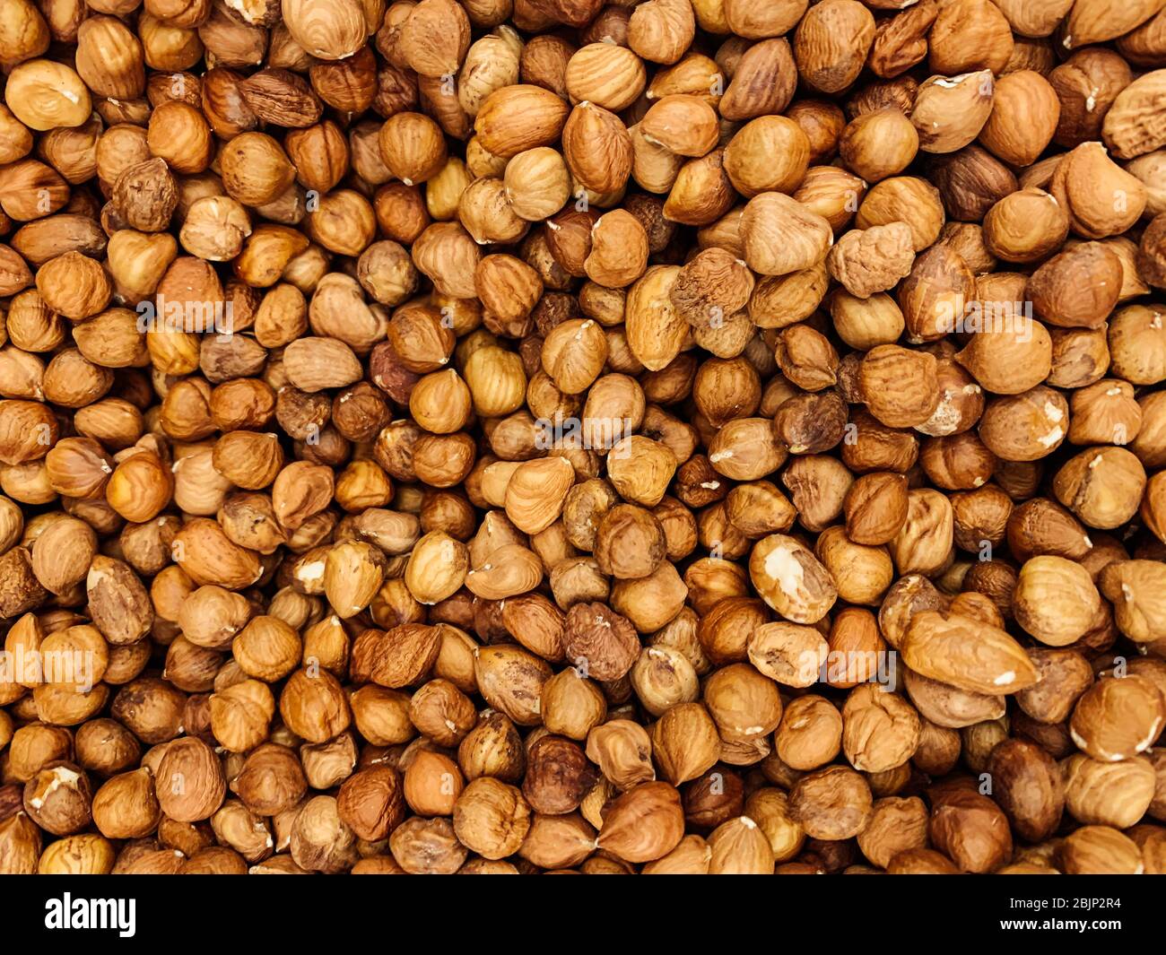 Attractive woman eating hazelnuts hi-res stock photography and images ...