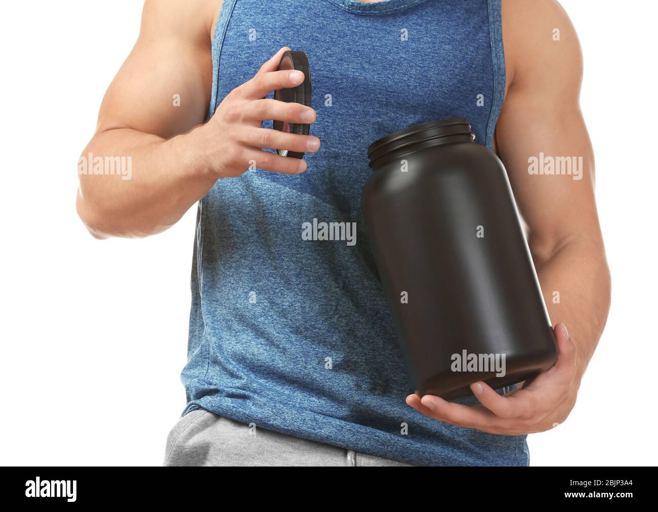 Sporty young man with jar of protein powder on white background Stock ...