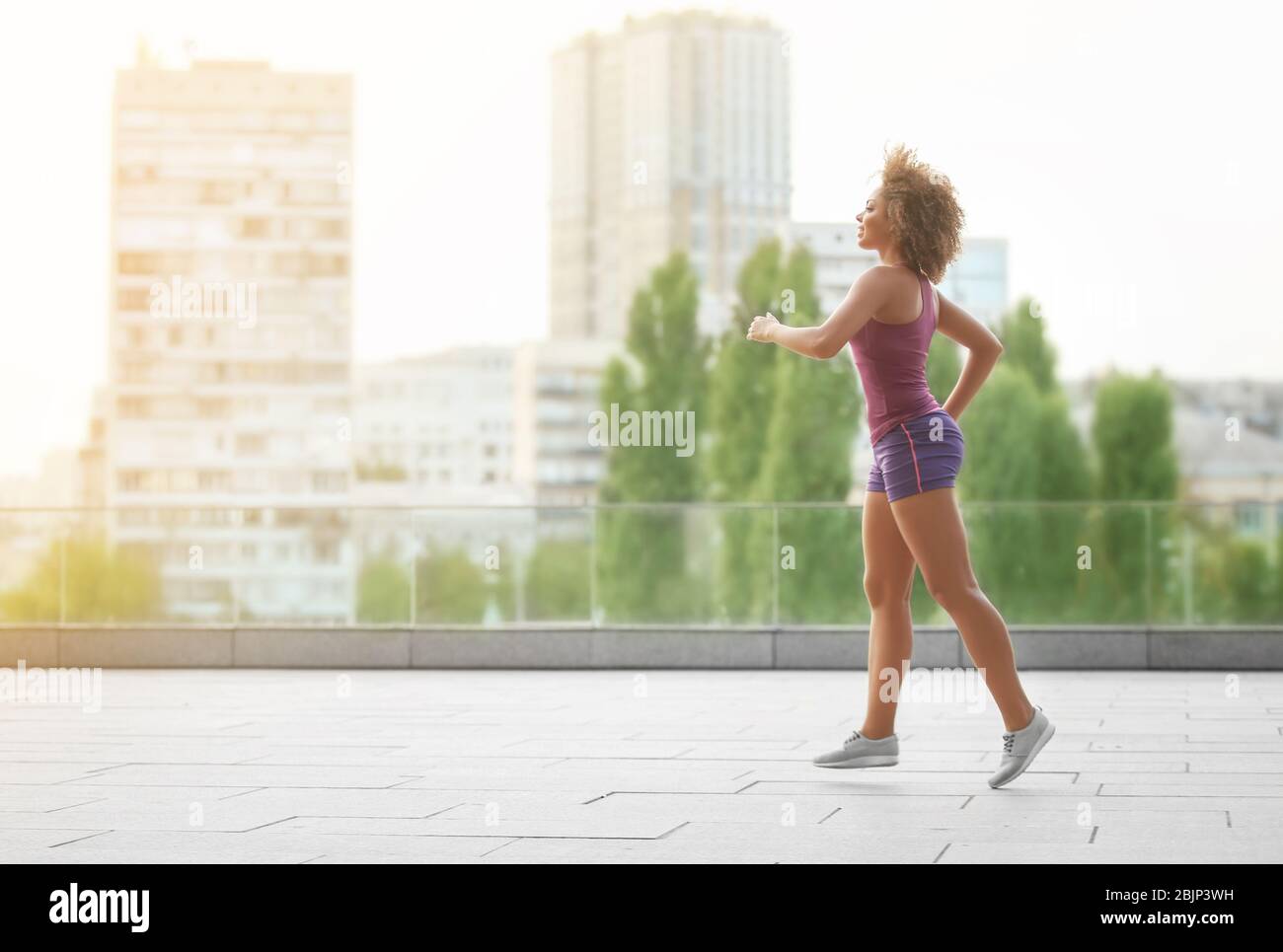 Sporty African American woman running outdoors Stock Photo - Alamy