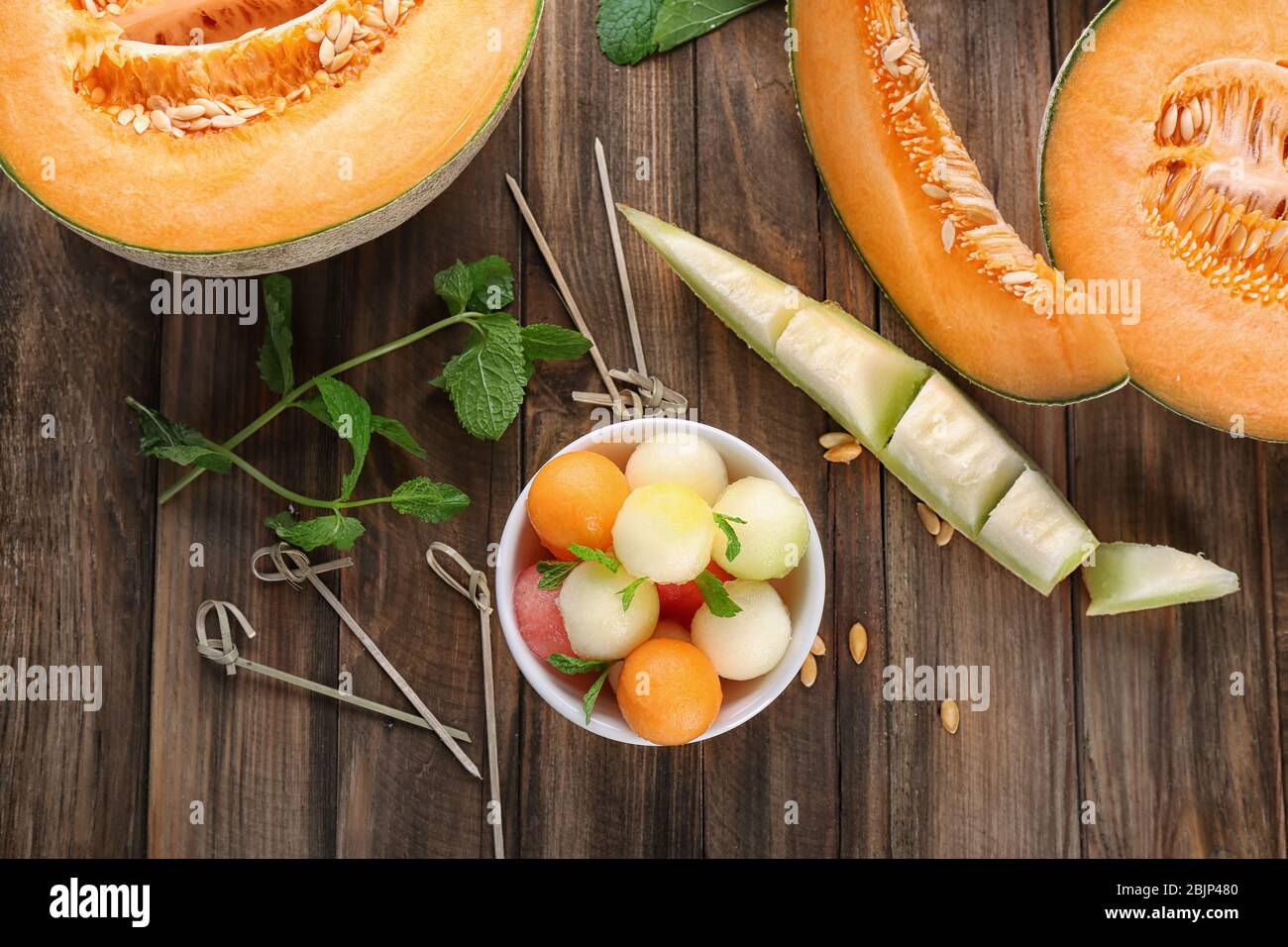 Bowl with fresh fruit balls on table Stock Photo - Alamy
