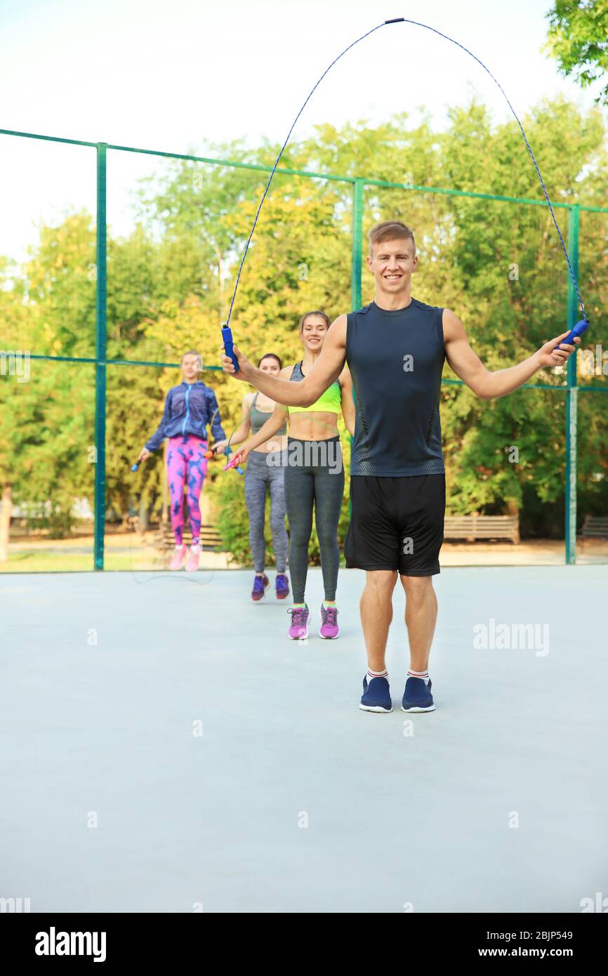 Young sporty people jumping rope outdoors Stock Photo - Alamy
