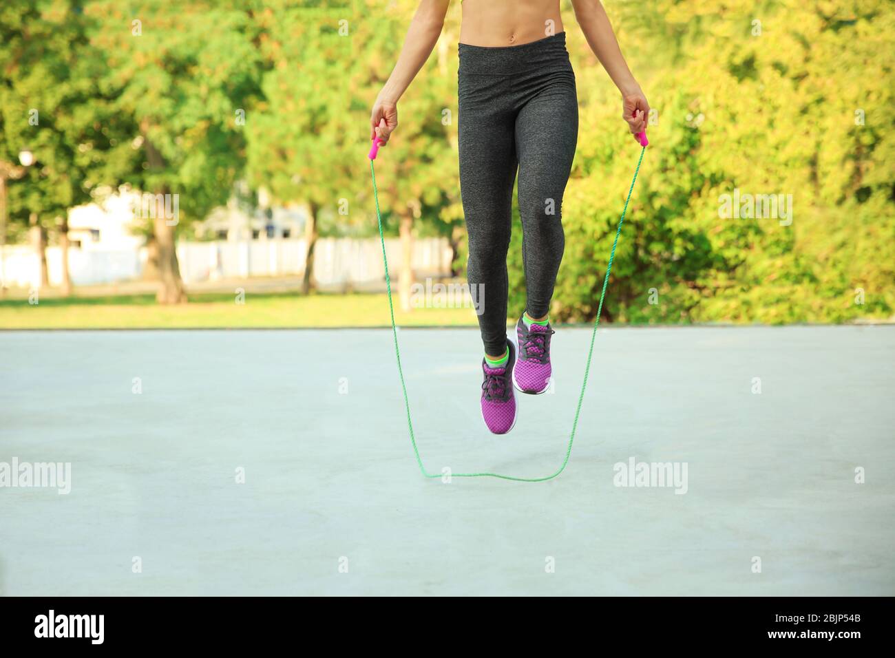 Legs sporty woman skipping rope hi-res stock photography and images - Alamy