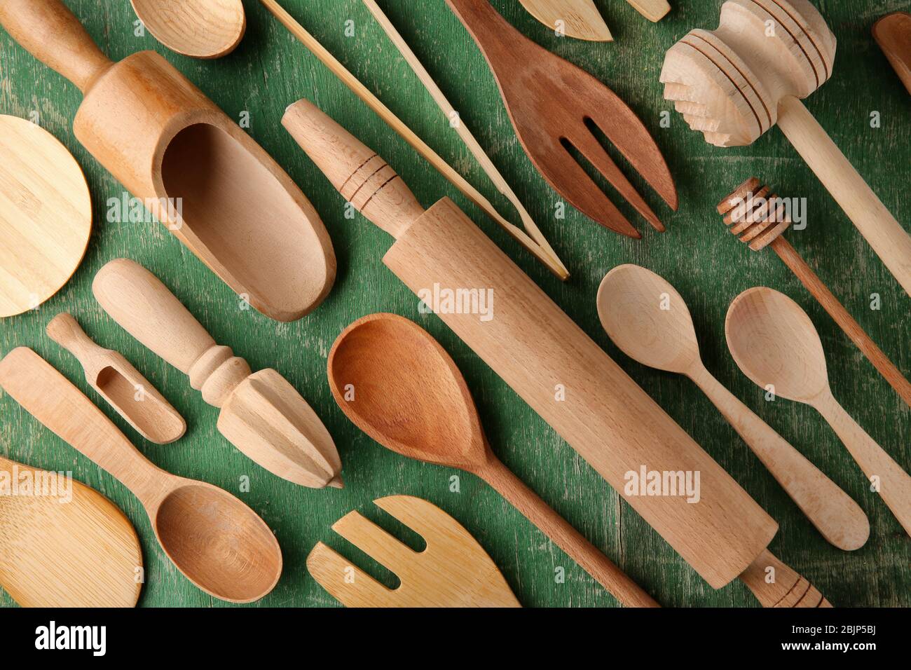 Various wooden kitchen utensils on color table Stock Photo - Alamy