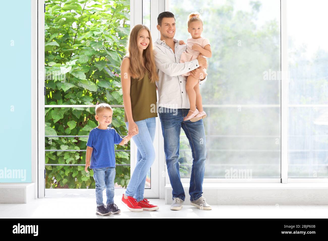 Happy family entering new house Stock Photo - Alamy