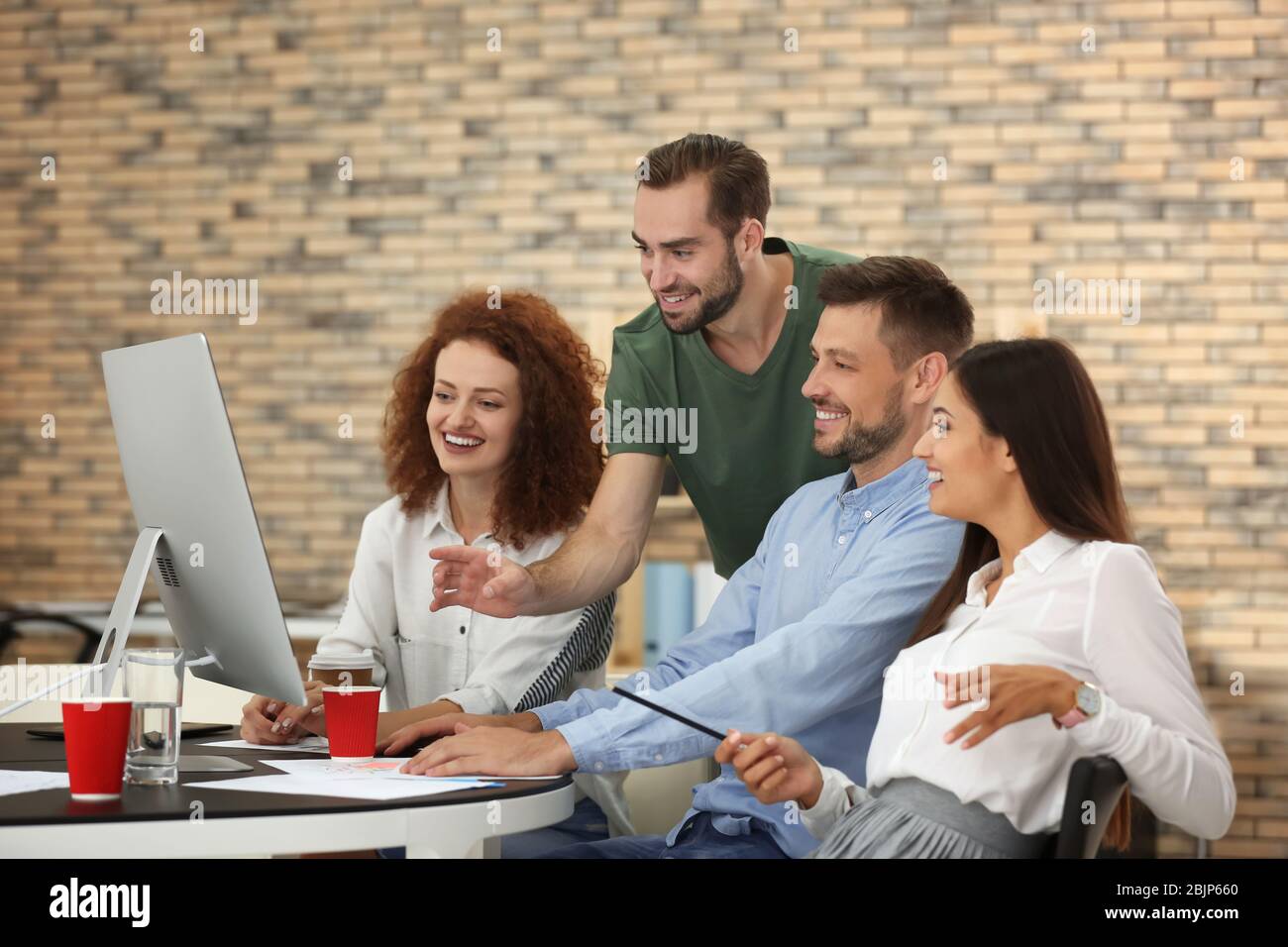 Team young professionals sitting table hi-res stock photography and ...