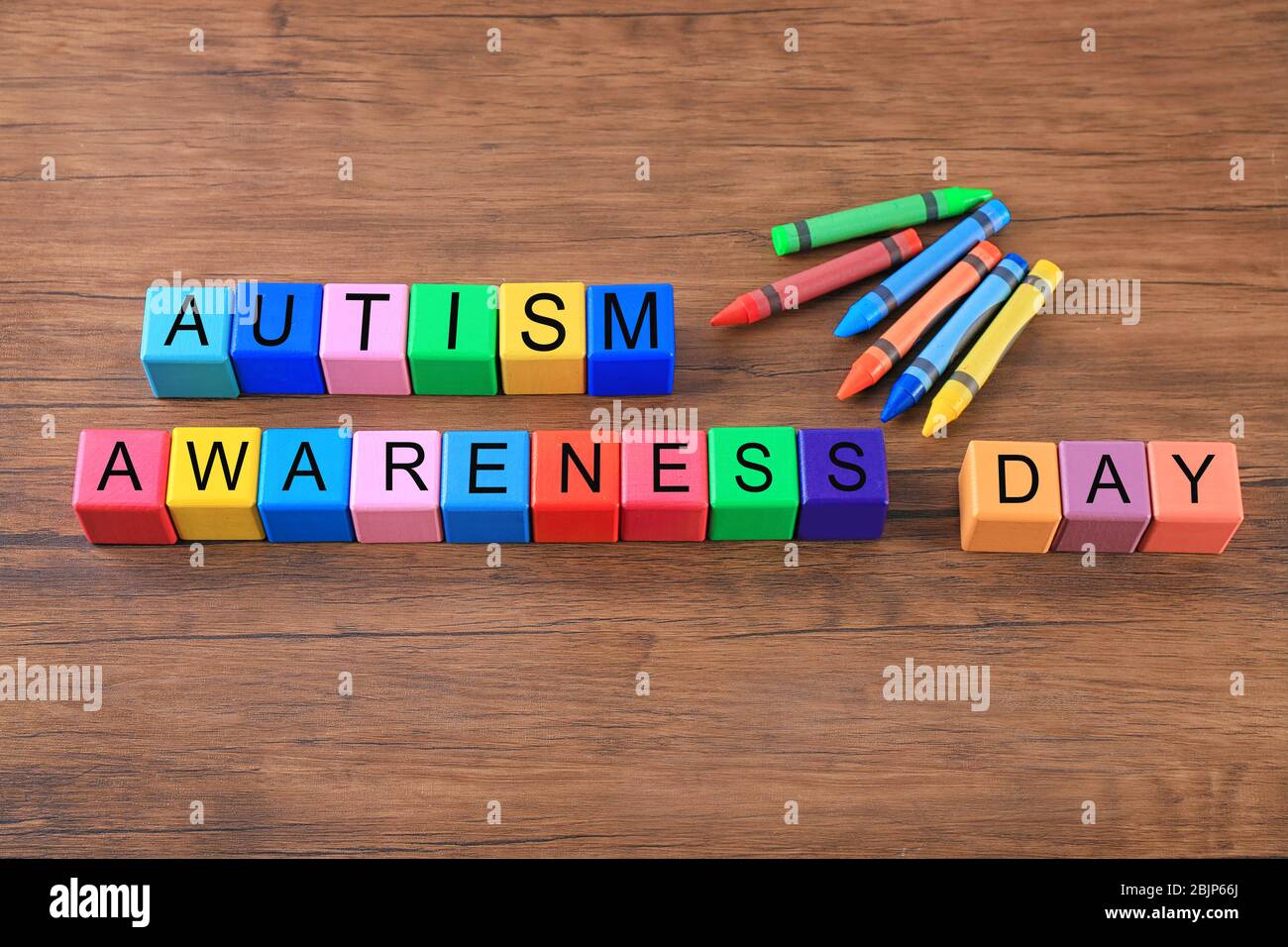 Colorful cubes with text on wooden background. Autism concept Stock ...