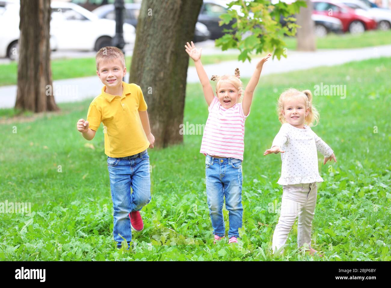 Adorable little children playing outdoors Stock Photo - Alamy
