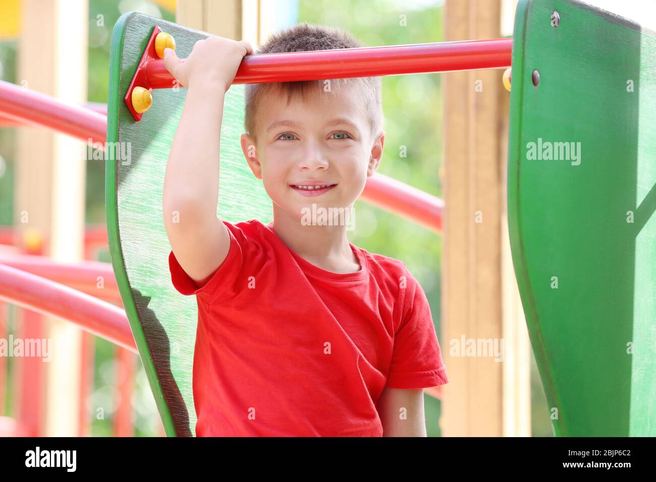 Adorable little boy on slide at playground Stock Photo - Alamy