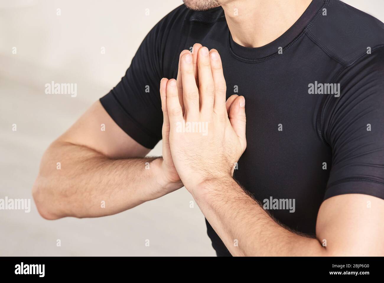 Yoga man hands. Namaste arm position. Gym studio Stock Photo - Alamy