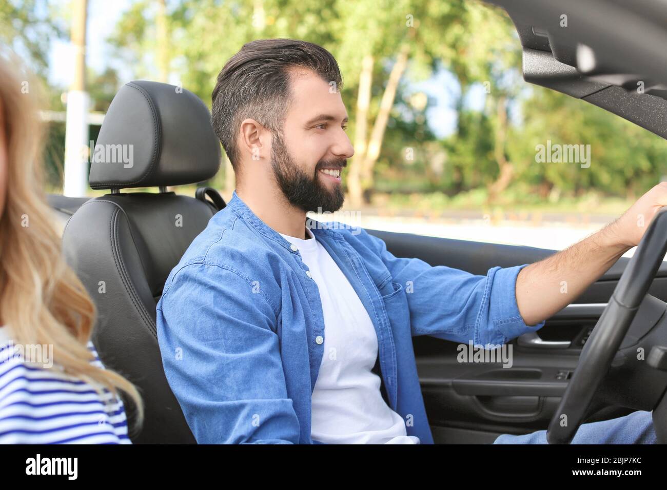 Happy young man driving a car Stock Photo - Alamy