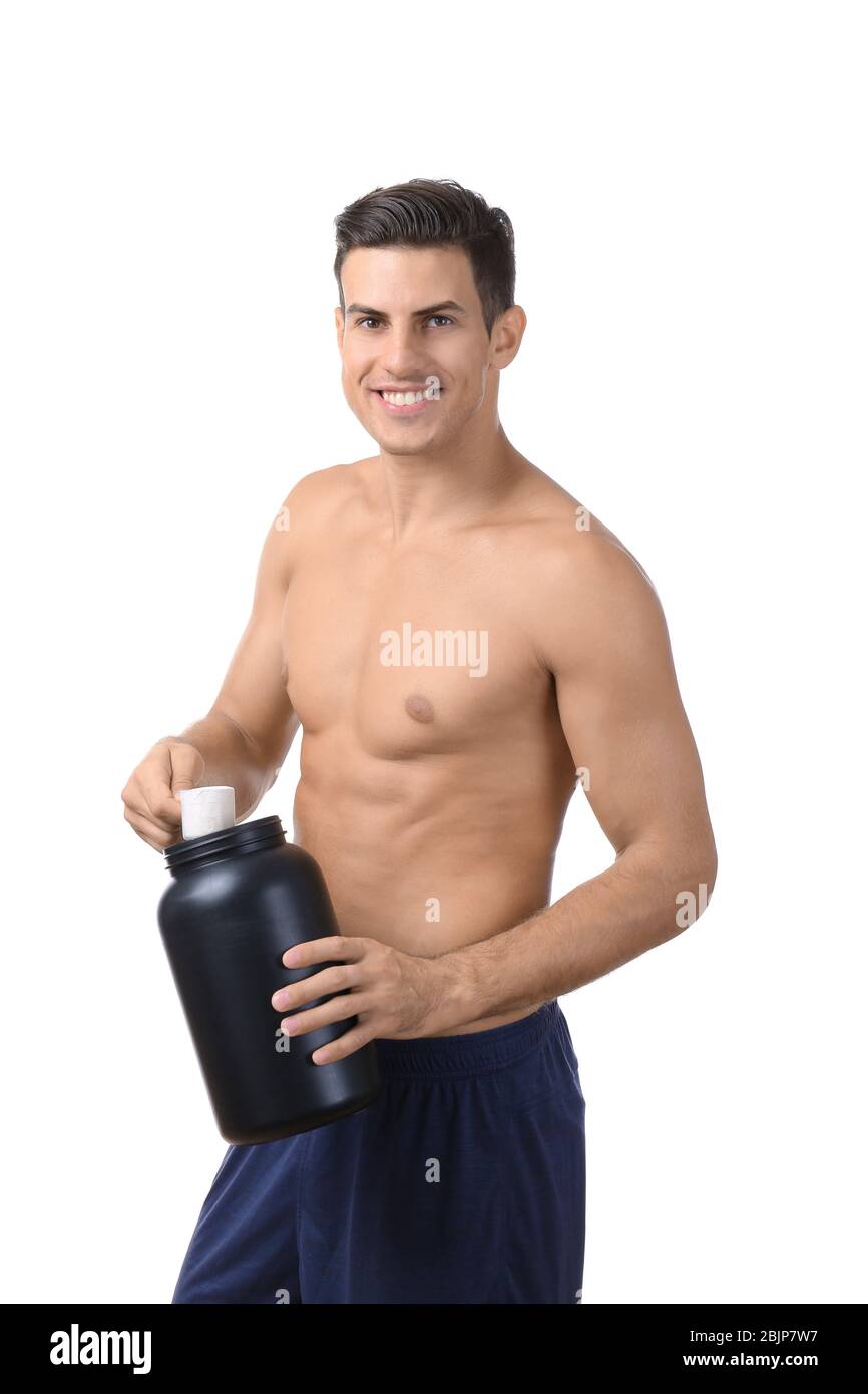 Shirtless young man holding black jar with protein powder on white ...