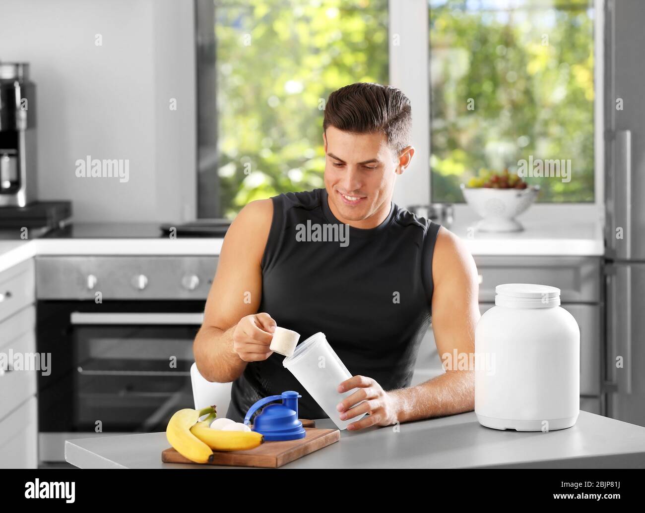 Muscular man preparing protein cocktail hi-res stock photography and ...