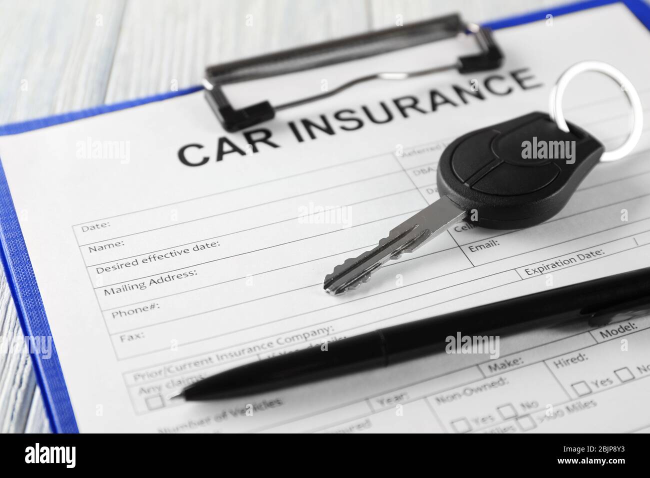 Car insurance form and key on table Stock Photo - Alamy