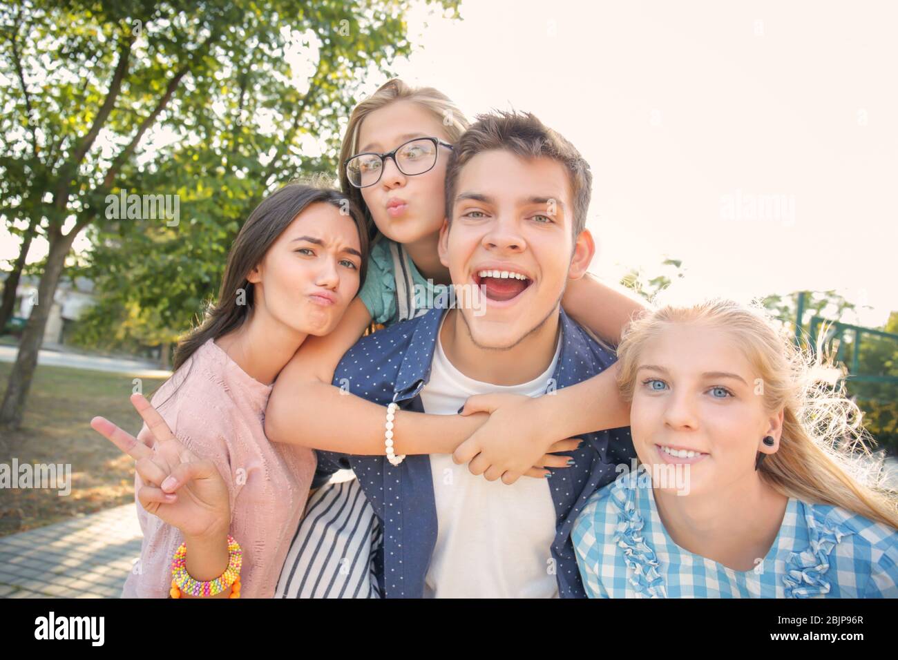 Happy teenagers posing outdoors Stock Photo - Alamy