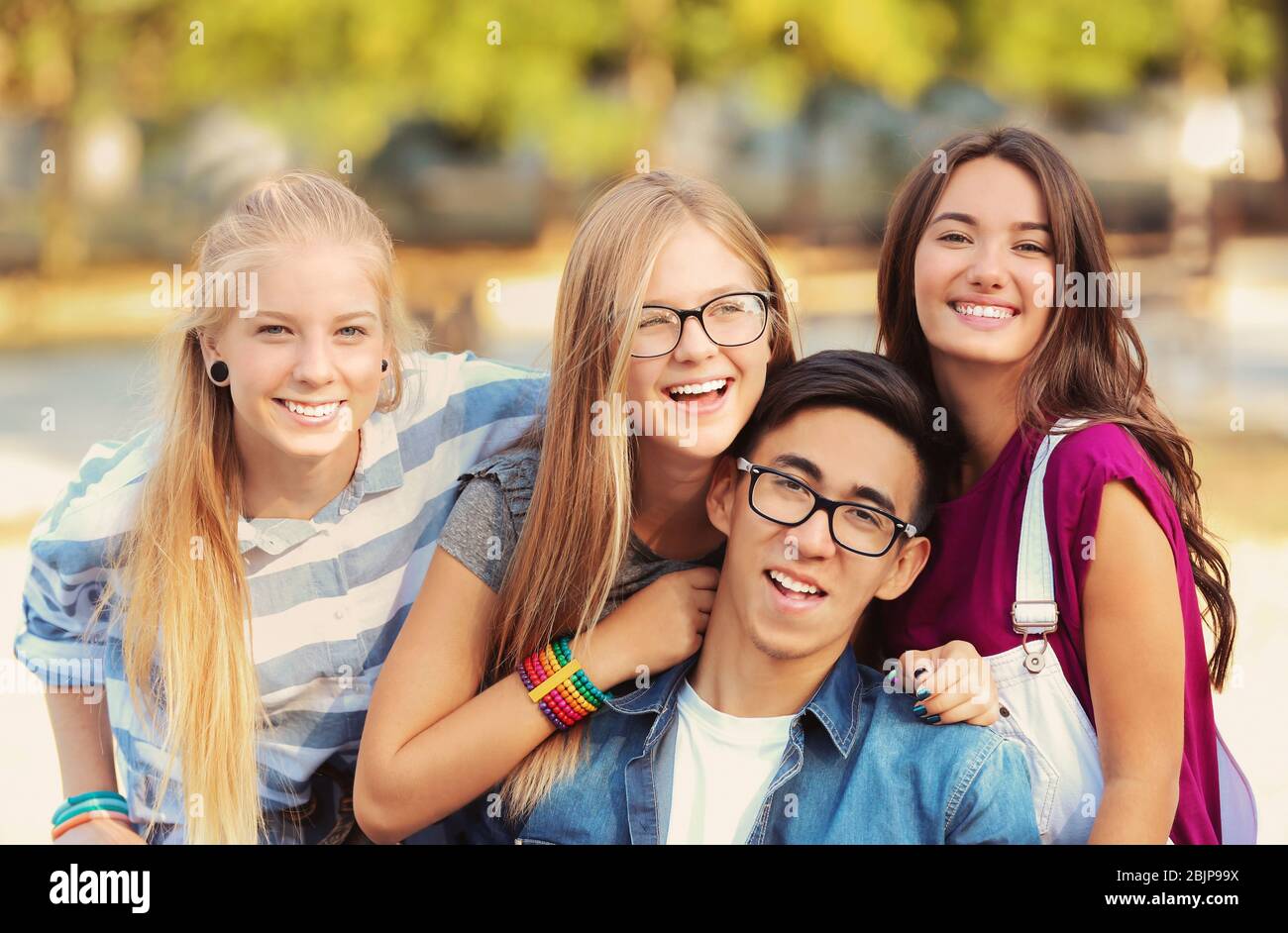 Happy teenagers posing on city street Stock Photo - Alamy