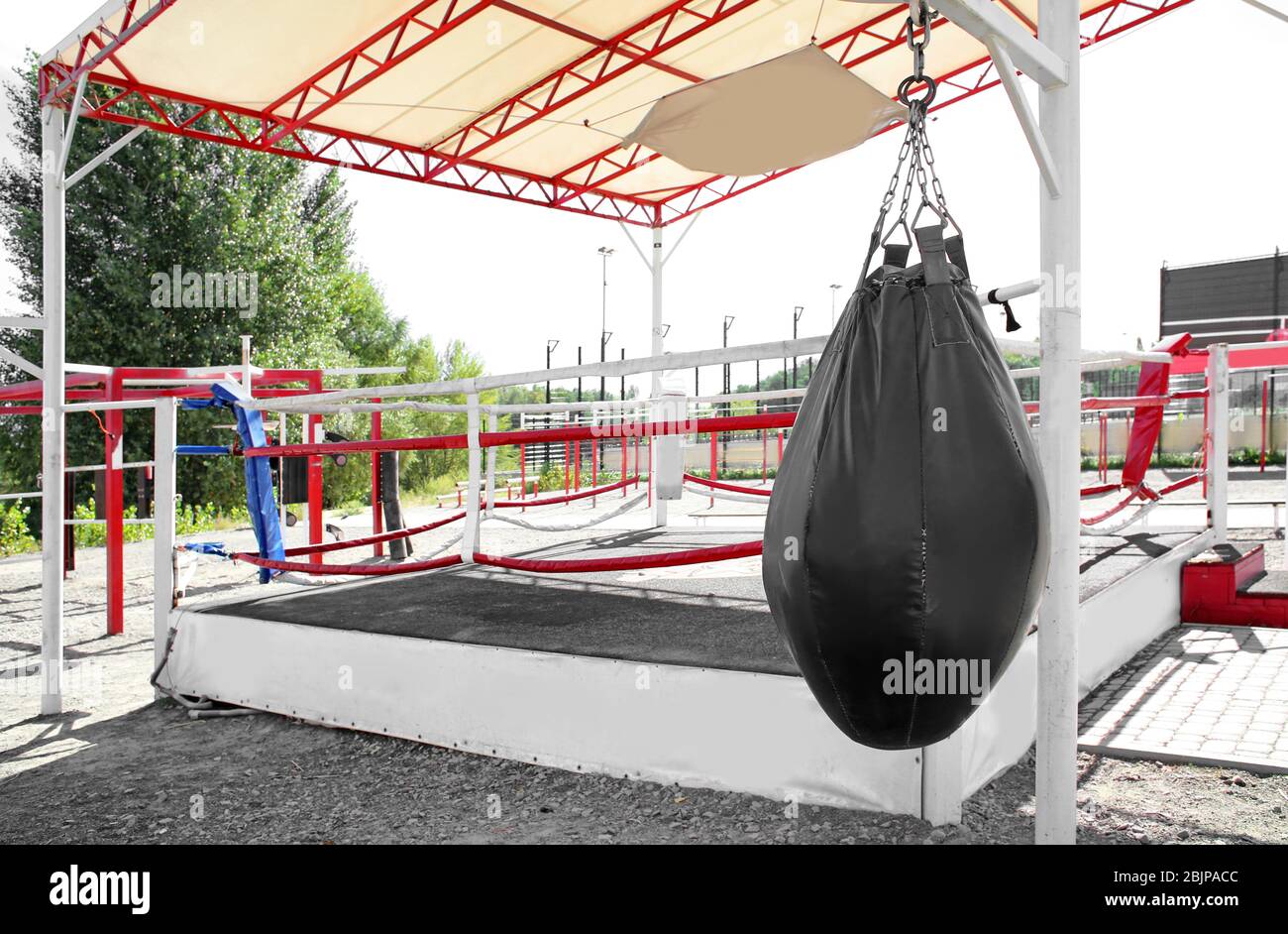 Punching bag near boxing ring prepared for competition, outdoors Stock ...