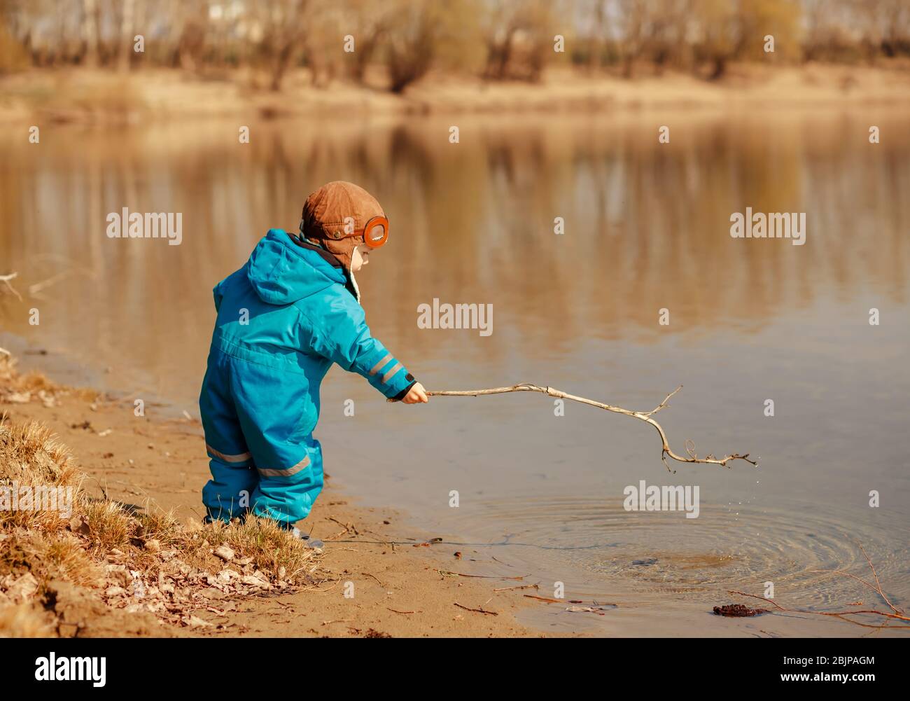 Cute child playing on the river in the open air. Active lifestyle Stock ...