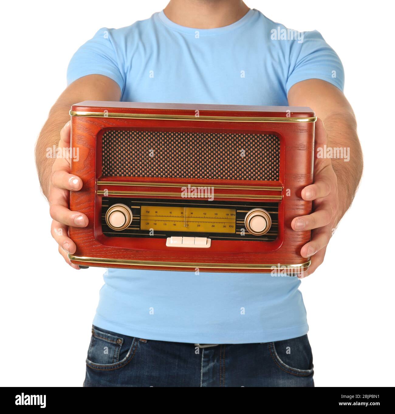 Young man holding retro radio on white background Stock Photo - Alamy