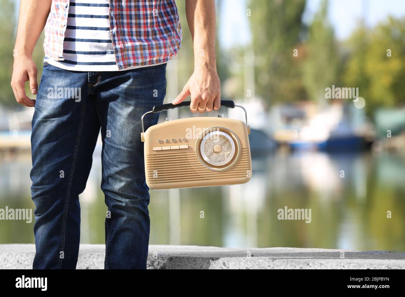 Young man with retro radio outdoors Stock Photo - Alamy