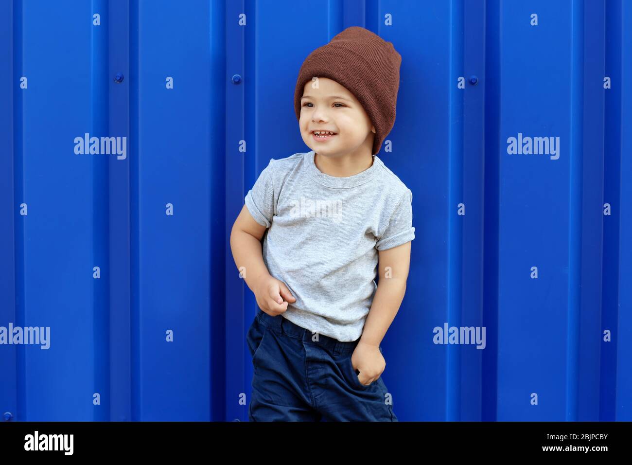 Adorable little boy on blue background Stock Photo - Alamy