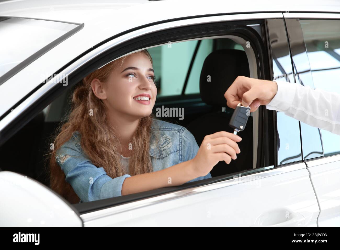Female customer receiving car key hi-res stock photography and images ...