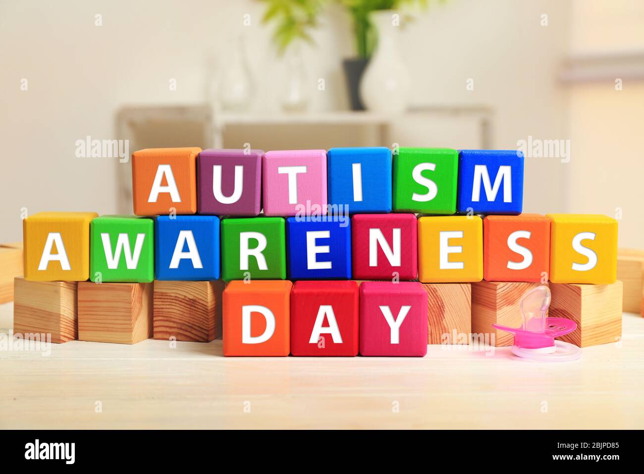 Cubes with text AUTISM SPECTRUM DAY on table Stock Photo - Alamy