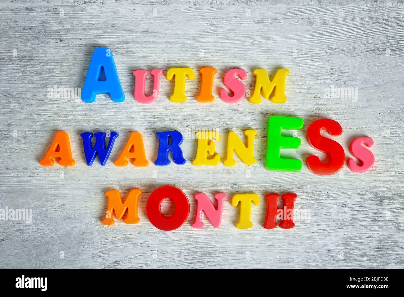 Text AUTISM AWARENESS MONTH on wooden background Stock Photo - Alamy