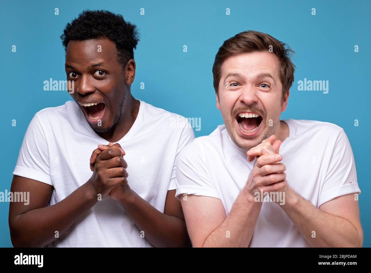 Two men are shocked, they open their mouths in amazement and look at ...